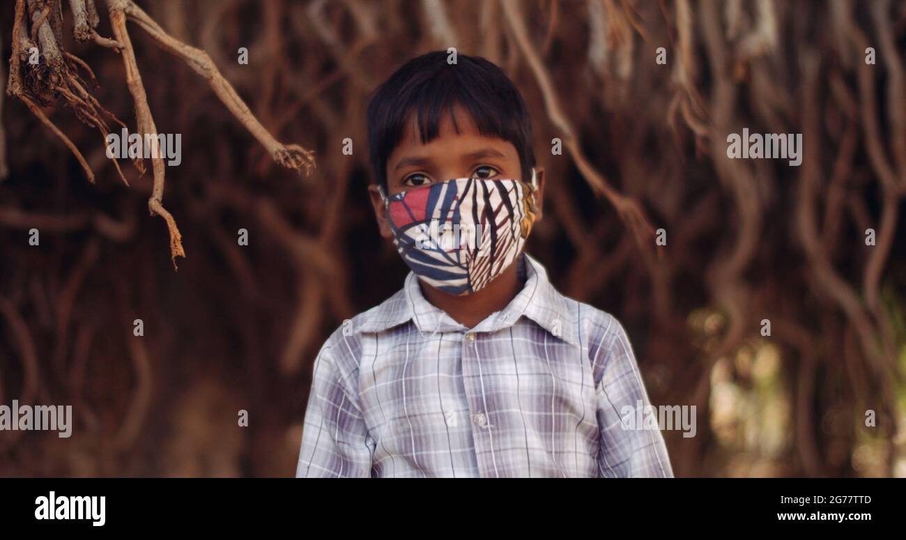 Closeup shot of an Indian boy wearing a mask- new normal concept Stock ...