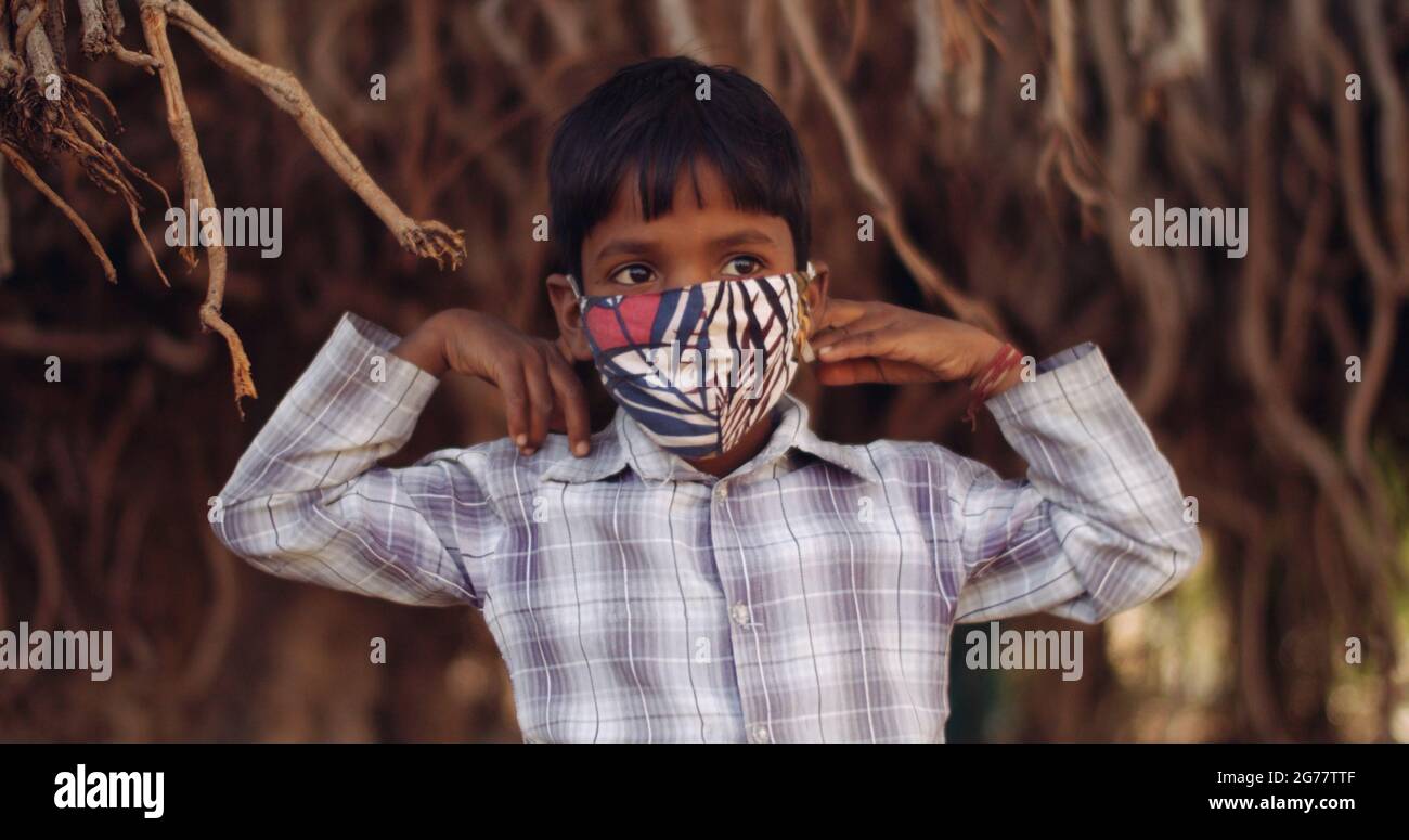 Closeup shot of an Indian boy wearing a mask- new normal concept Stock ...