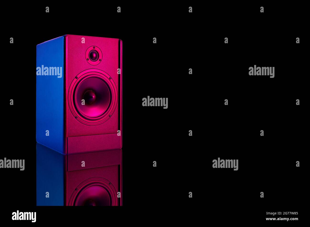 Neon colored stereo speaker on dark background with reflection.Sound ...