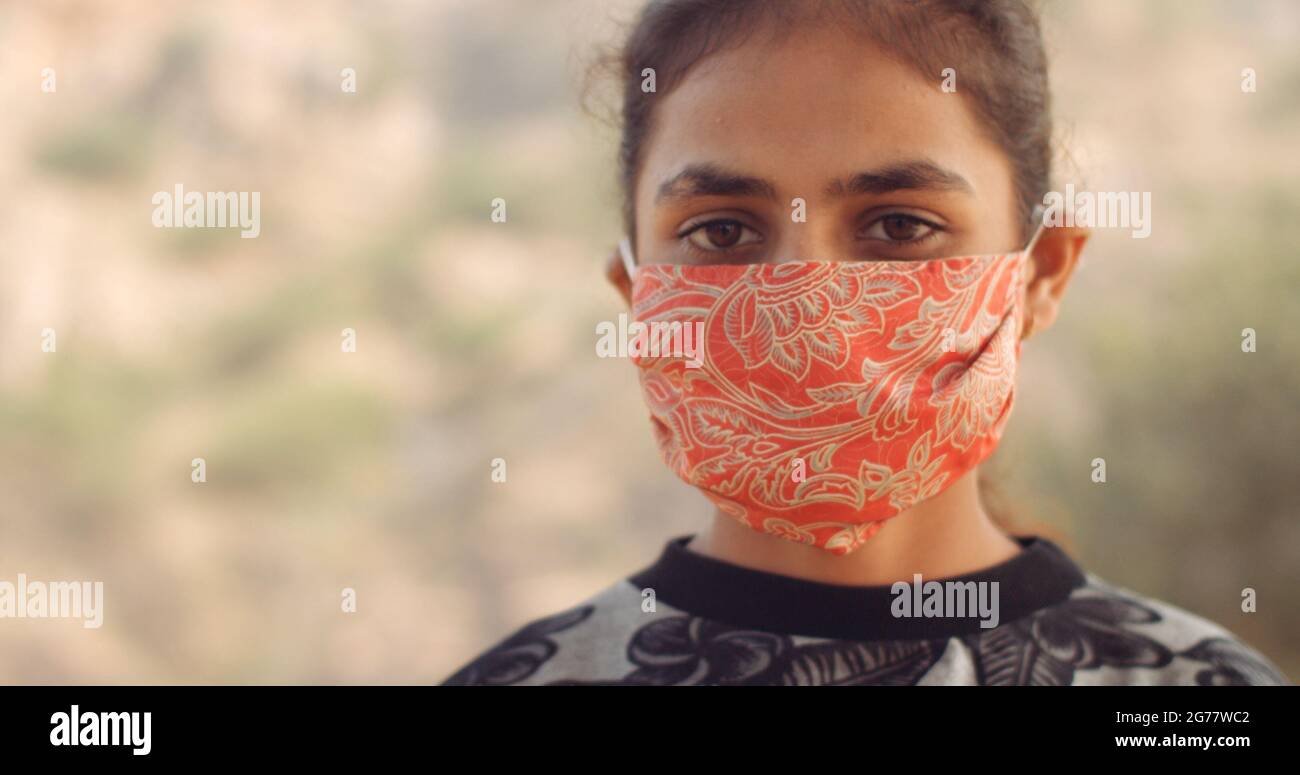 Shallow focus of an Indian girl wearing a face mask- new normal concept Stock Photo - Alamy