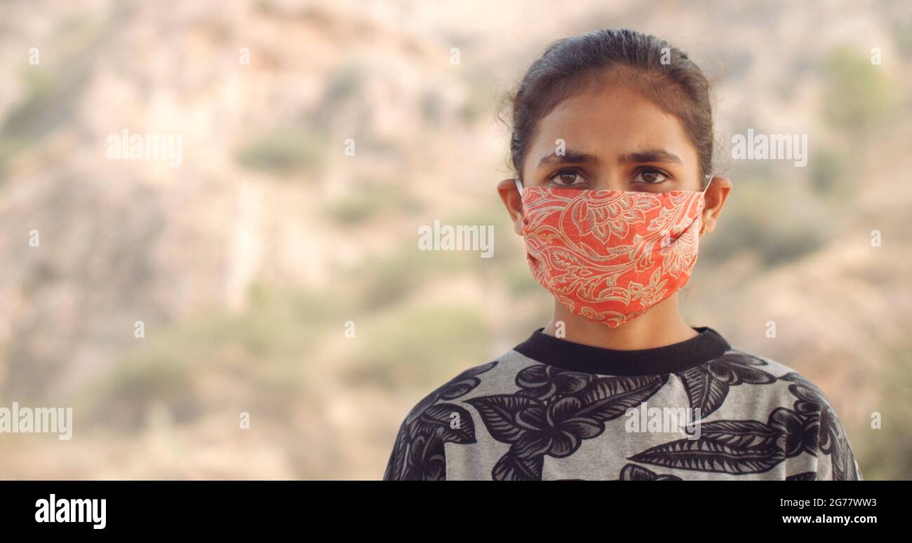 Closeup shot of an Indian girl wearing a mask- new normal concept Stock Photo - Alamy