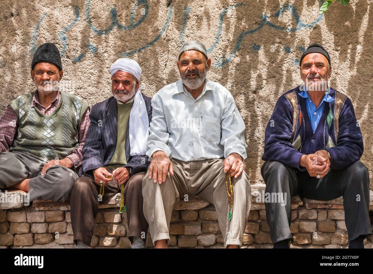 Old friends sitting and resting under shade of tree, Tus(Tous), suburb ...