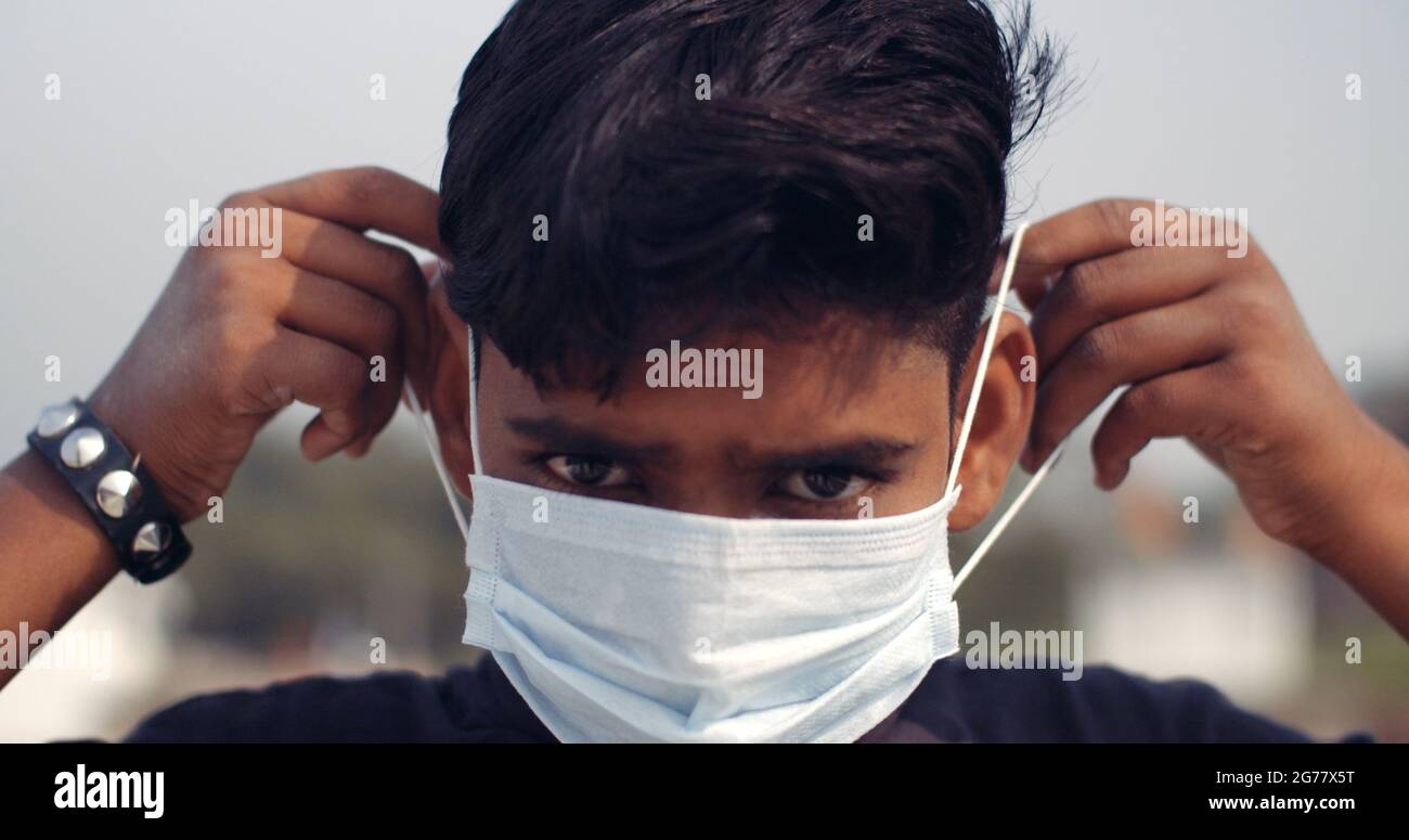 Closeup shot of an Indian boy wearing a mask- new normal concept Stock ...