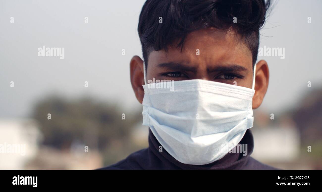 Closeup shot of an Indian boy wearing a mask- new normal concept Stock ...