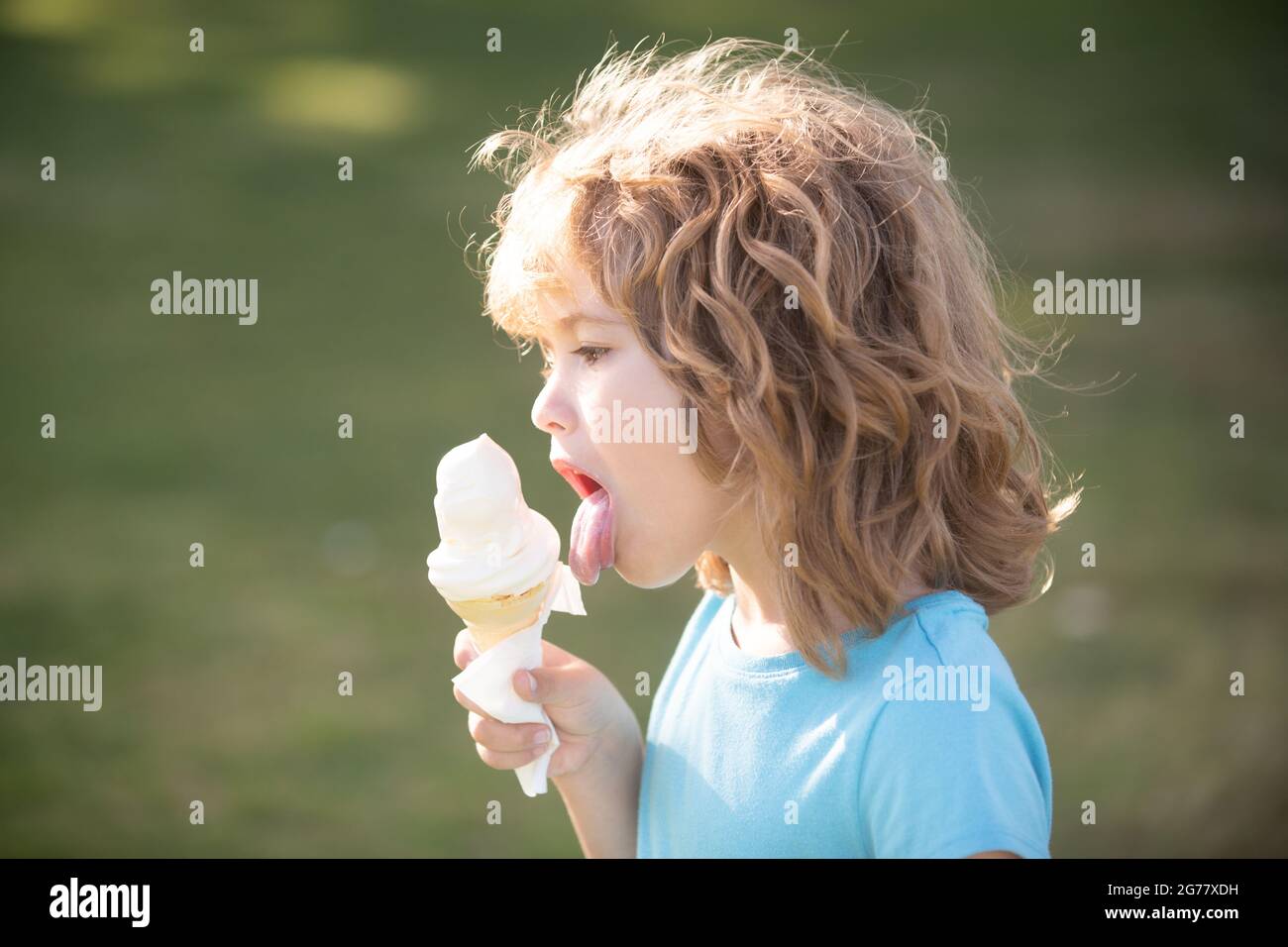 Portrait of a cute child boy eating ice cream. Close up caucasian kids ...