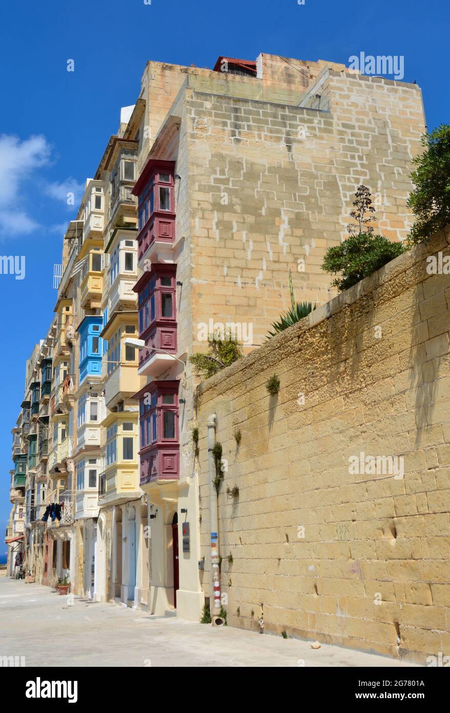Vertical shot of a typical residential street with houses in Valletta ...