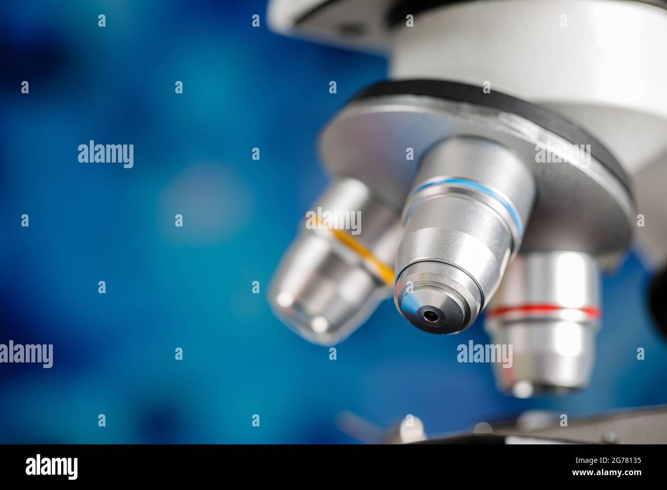 Close up shot of microscope lens and colorful blur blue background copy ...