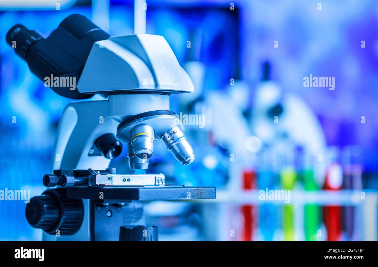 Microscope in and laboratory with chemical test tube equipment in lab ...