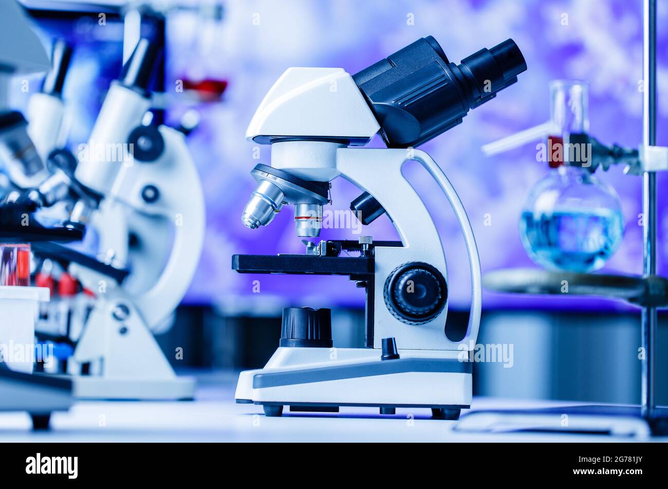 Microscope in and laboratory with chemical test tube equipment in lab ...