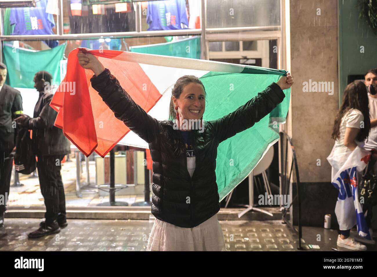 London, UK. 11th July, 2021. Italy fan holds an Italian flag to ...