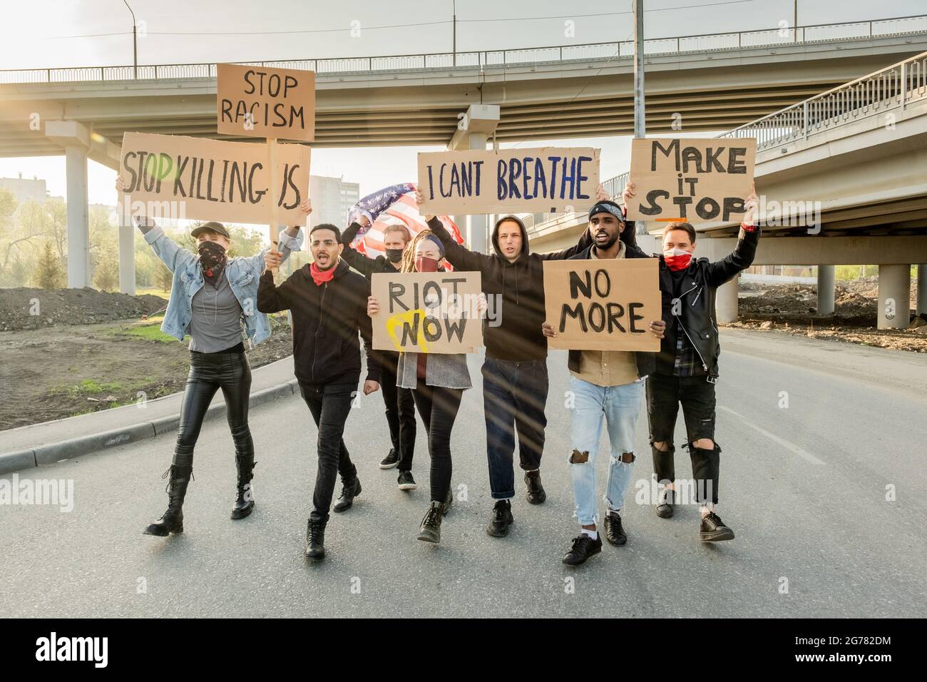 Group of angry young multi-ethnic people raising cardboard banners ...