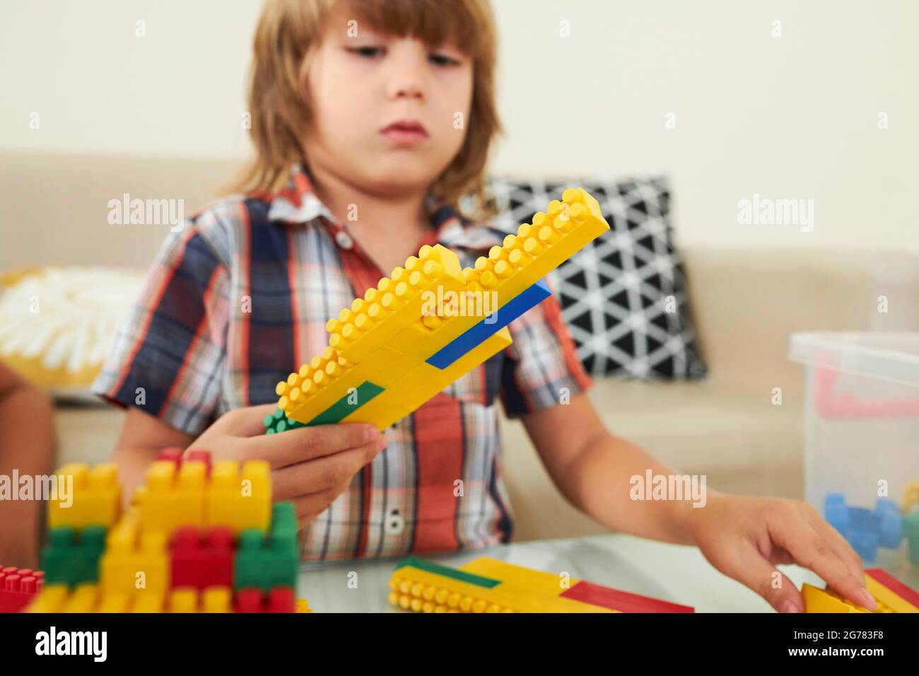 Boy playing building bricks in hi-res stock photography and images - Alamy