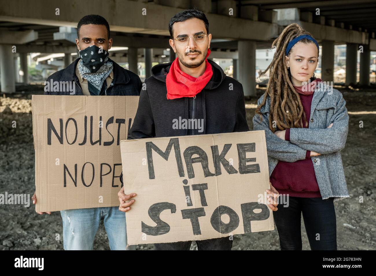 Confident young multi-ethnic rebellion people standing with signs and ...