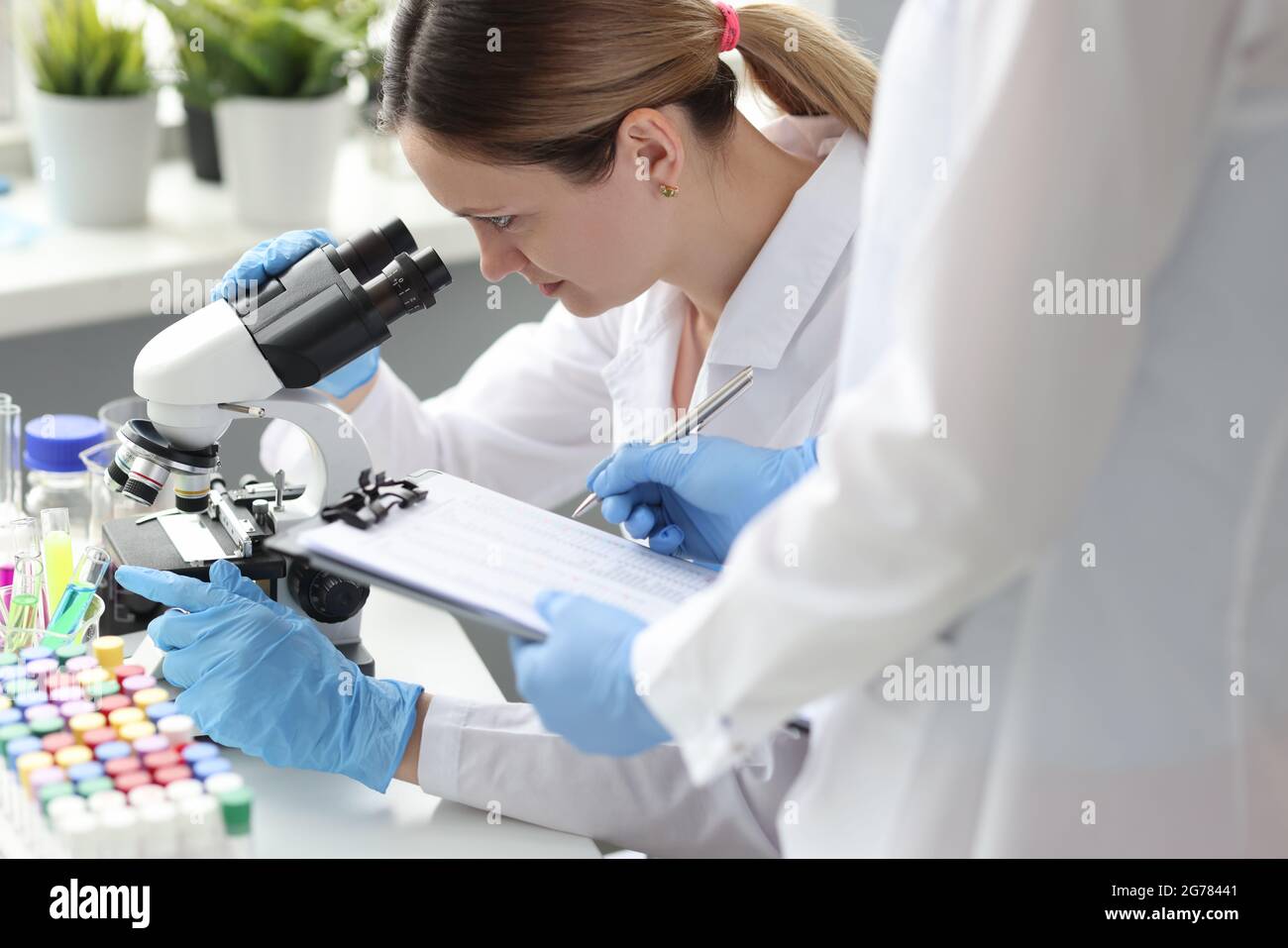Woman scientist conducts test of chemical composition of substance ...