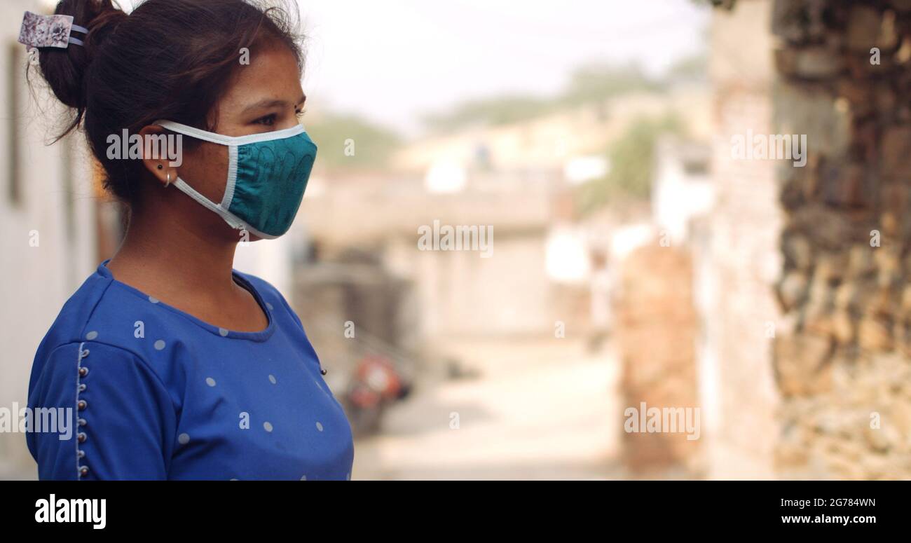 Shallow focus of an Indian girl wearing a face mask- new normal concept Stock Photo - Alamy