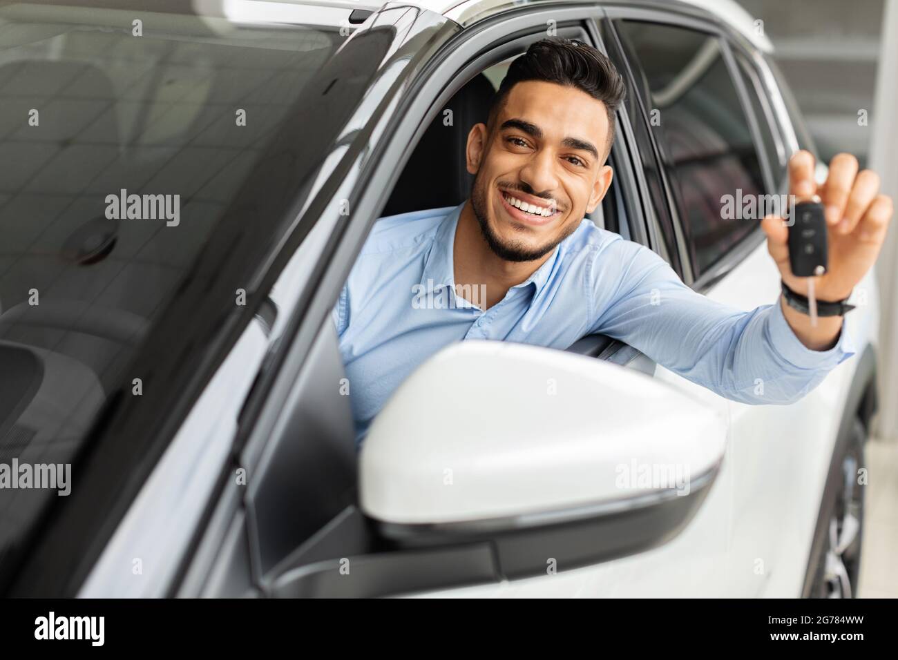 Happy arab man holding key from auto, buying car Stock Photo - Alamy