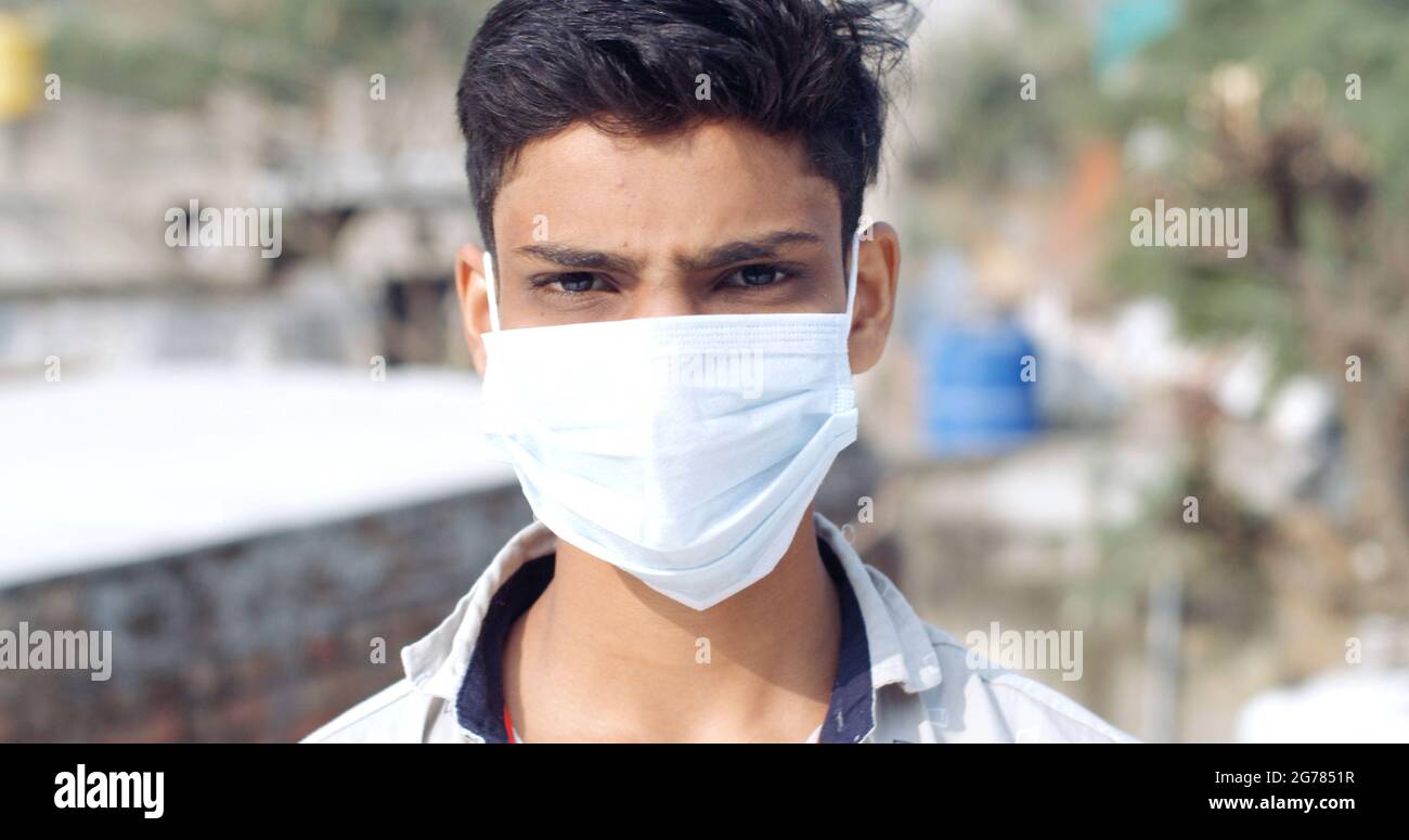 Closeup shot of an Indian boy wearing a mask- new normal concept Stock ...