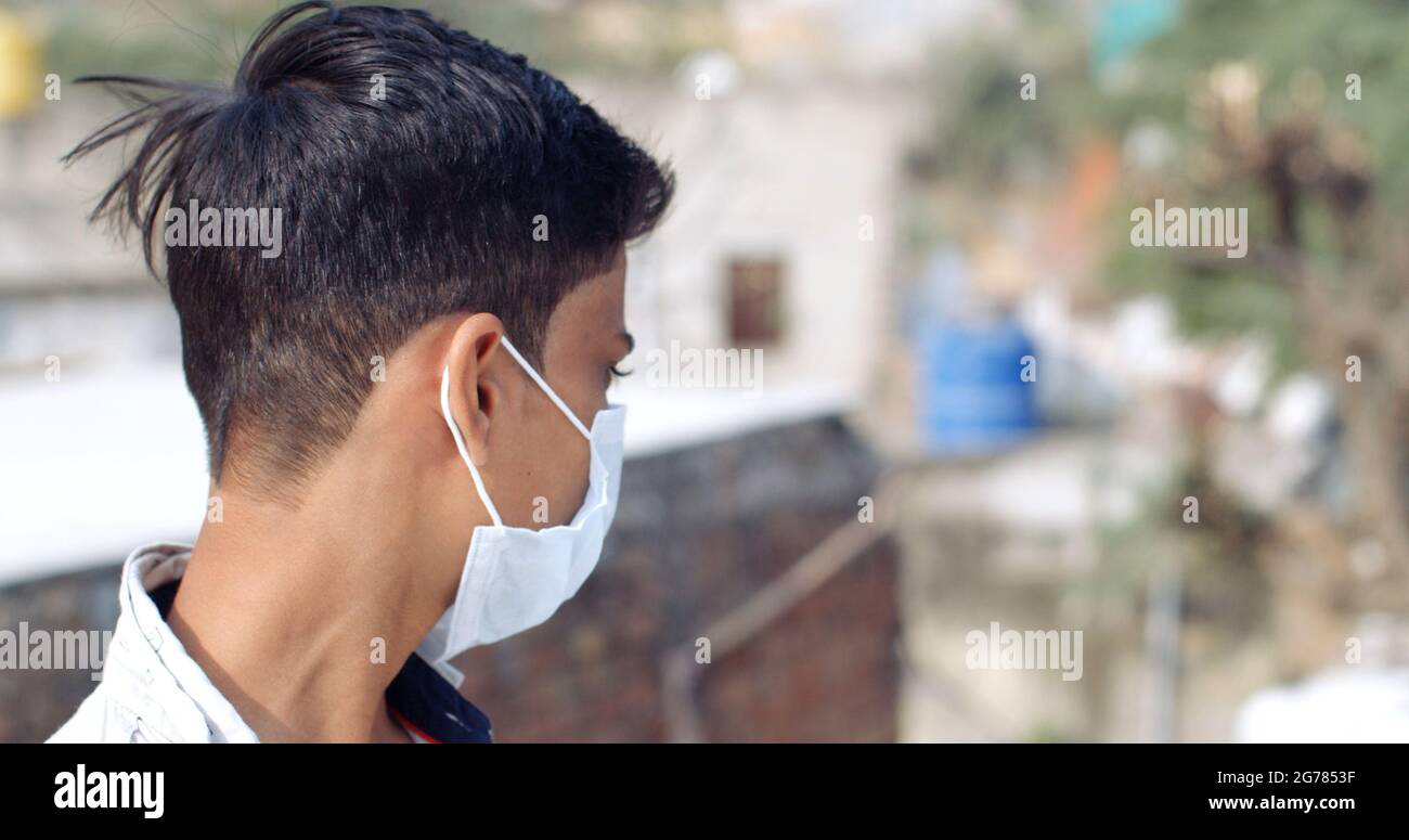 Closeup shot of an Indian boy wearing a mask- new normal concept Stock ...