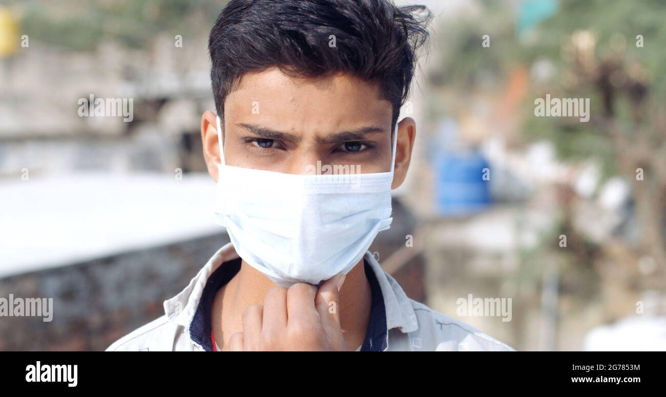 Closeup shot of an Indian boy wearing a mask- new normal concept Stock ...