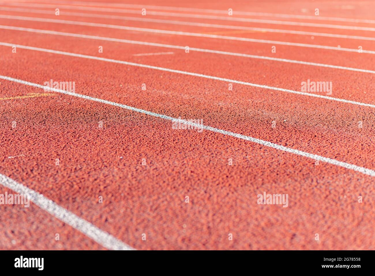 Part Red plastic track in the outdoor track and field stadium.Closeup ...