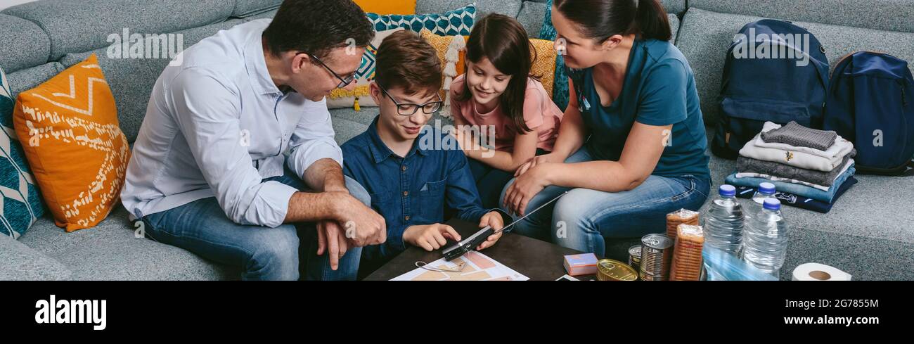 Parents explaining to their children how to use the radio in an Stock ...