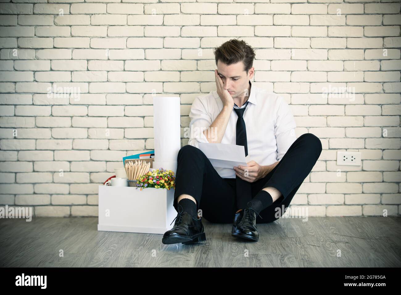 Young caucasian businessman tired sitting with feel sad, stressed and ...