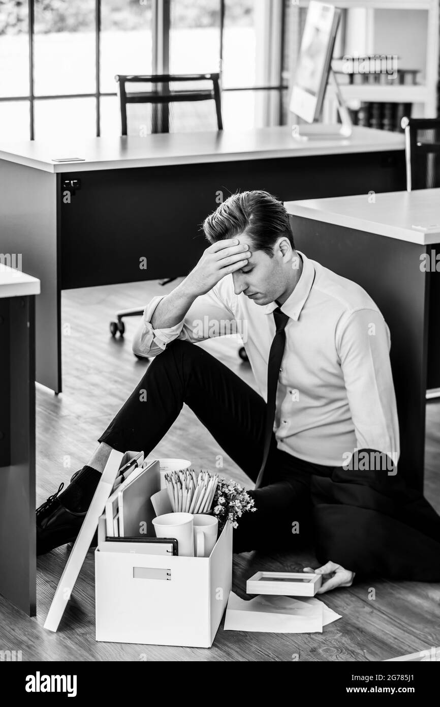 Young caucasian businessman in suit tired sitting with feeling sad ...