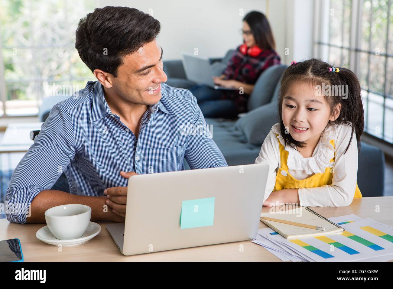 Mixed race family staying together, Caucasian father sitting and ...