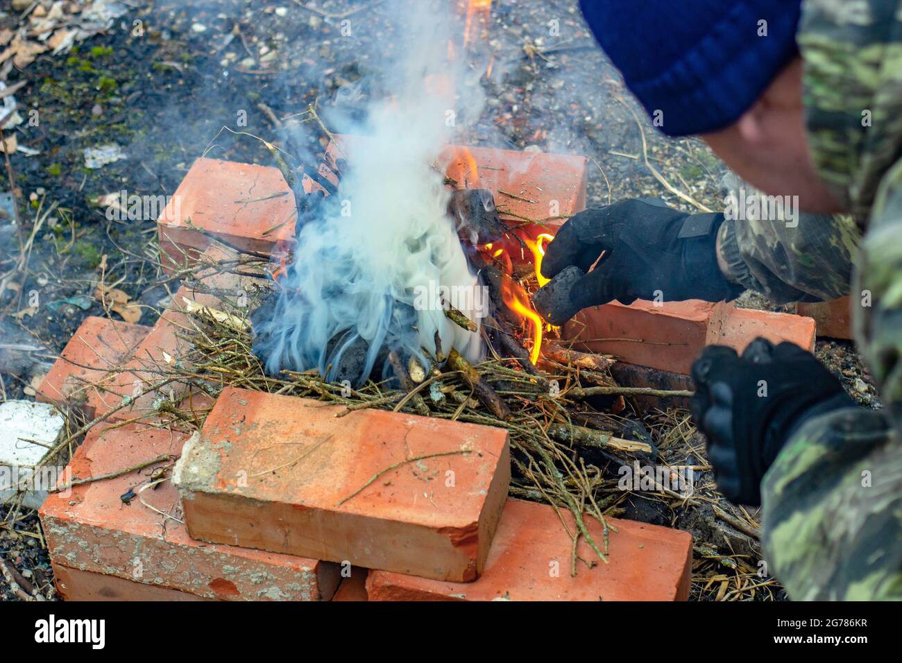 man makes a fire in a bonfire Stock Photo - Alamy