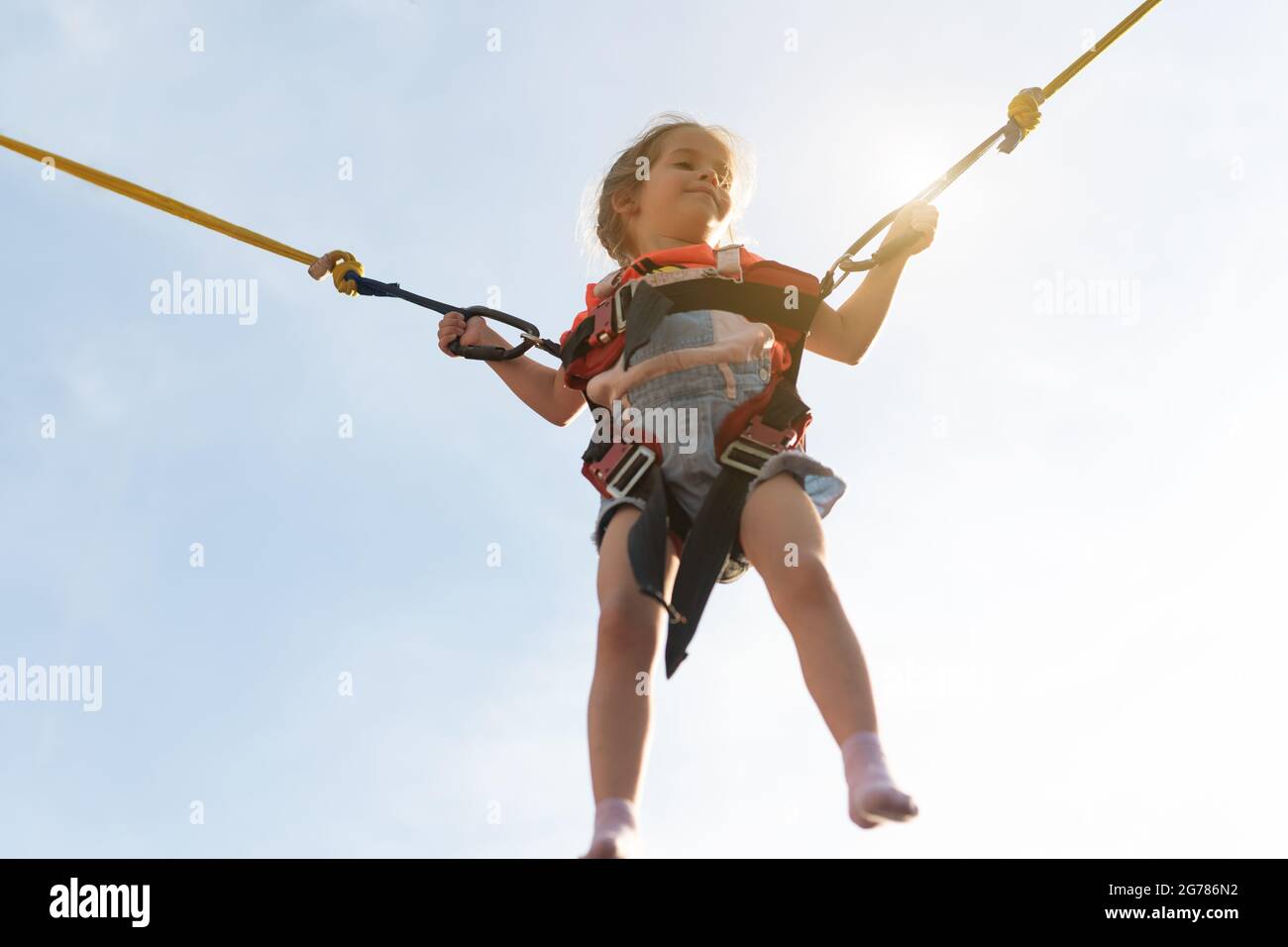 Child jumping child trampoline rubber bands Amusement park Little girl ...