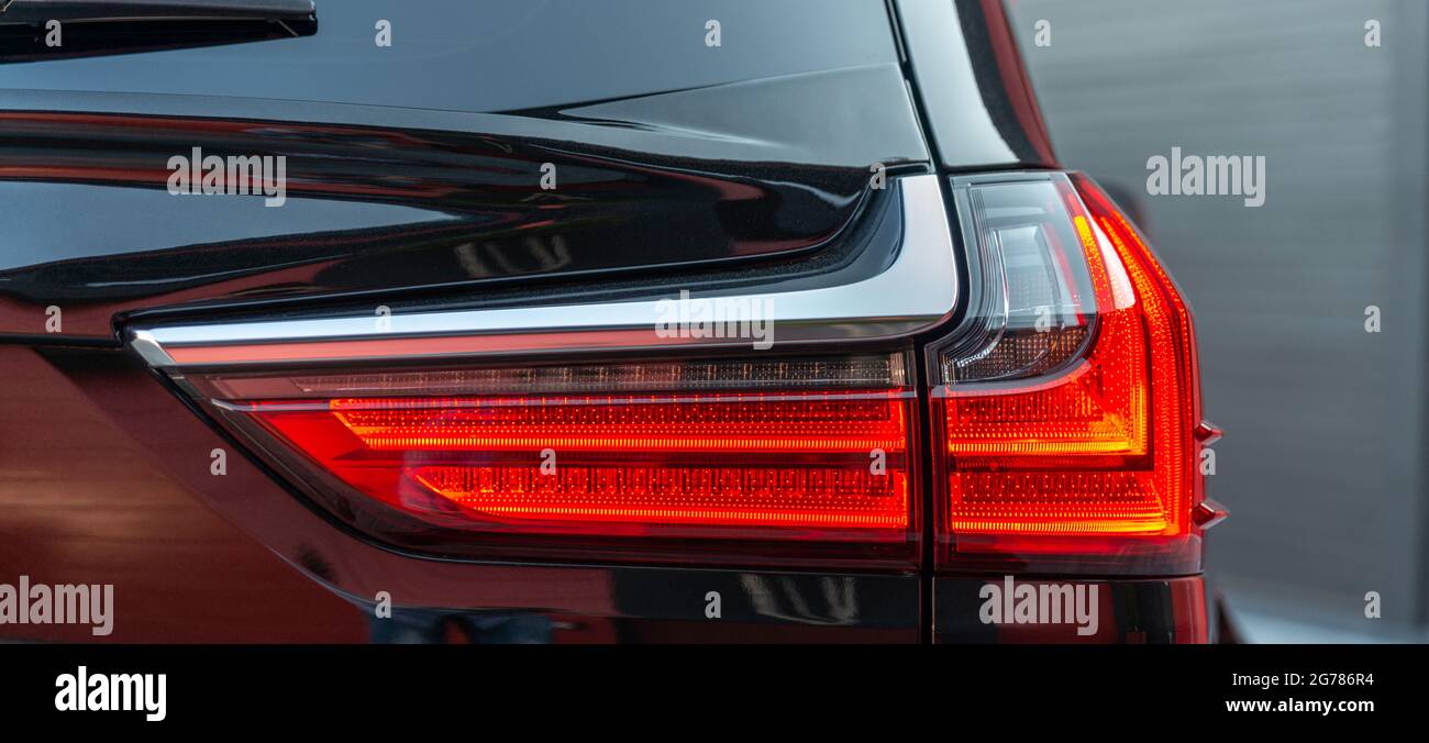 The red headlight of a modern black car. Rear stop light of large suv ...