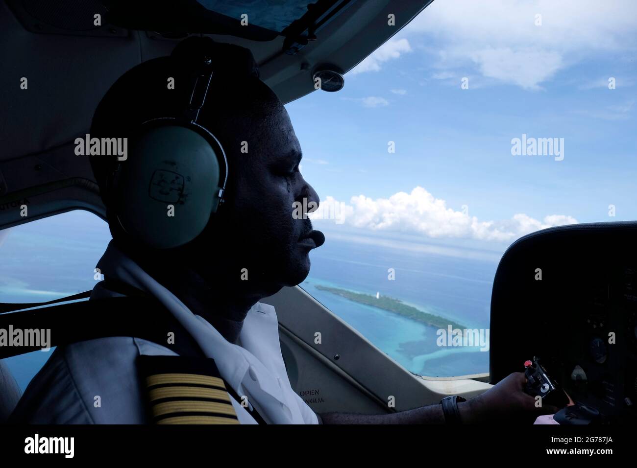An African pilot controls the flight of an aircraft over the Zanzibar ...