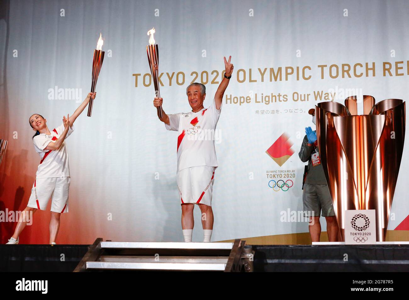 Tokyo, Japan. 12th July, 2021. Torchbearers pose for the cameras during ...
