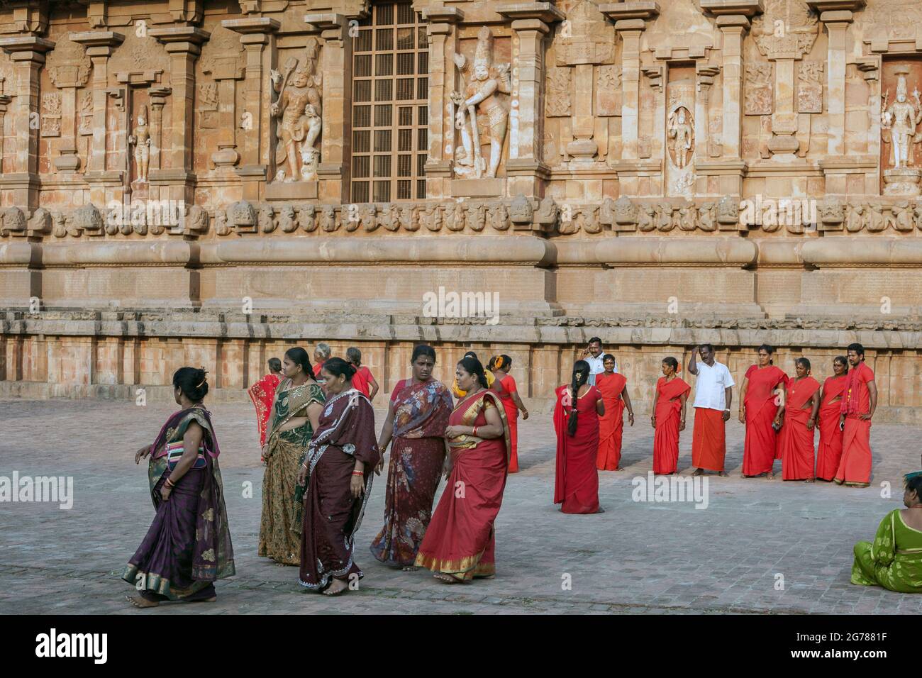 Group of Indian hindu devotees in red saris and lunghis pose for ...