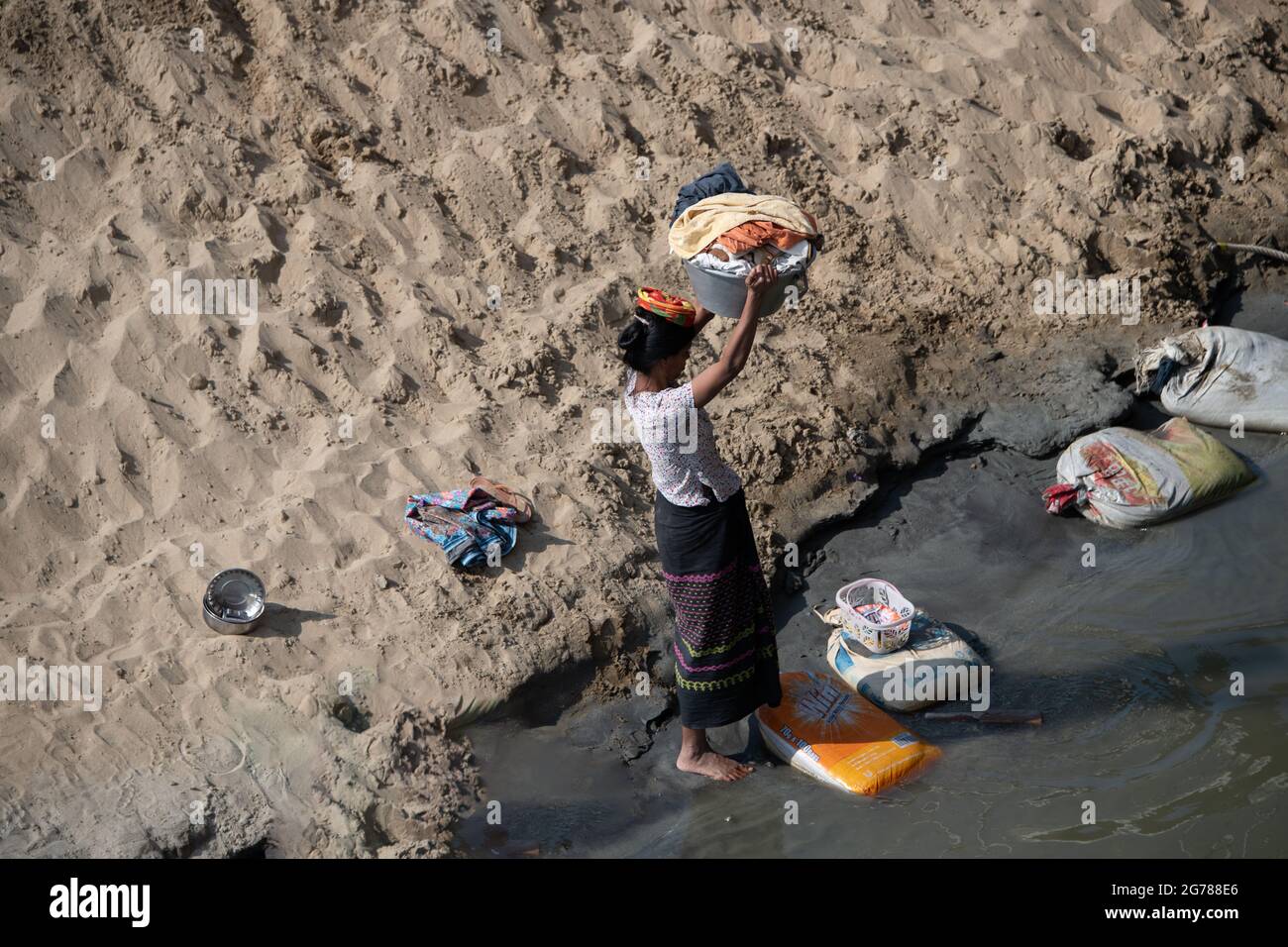 Women hand washing clothes hi-res stock photography and images - Alamy