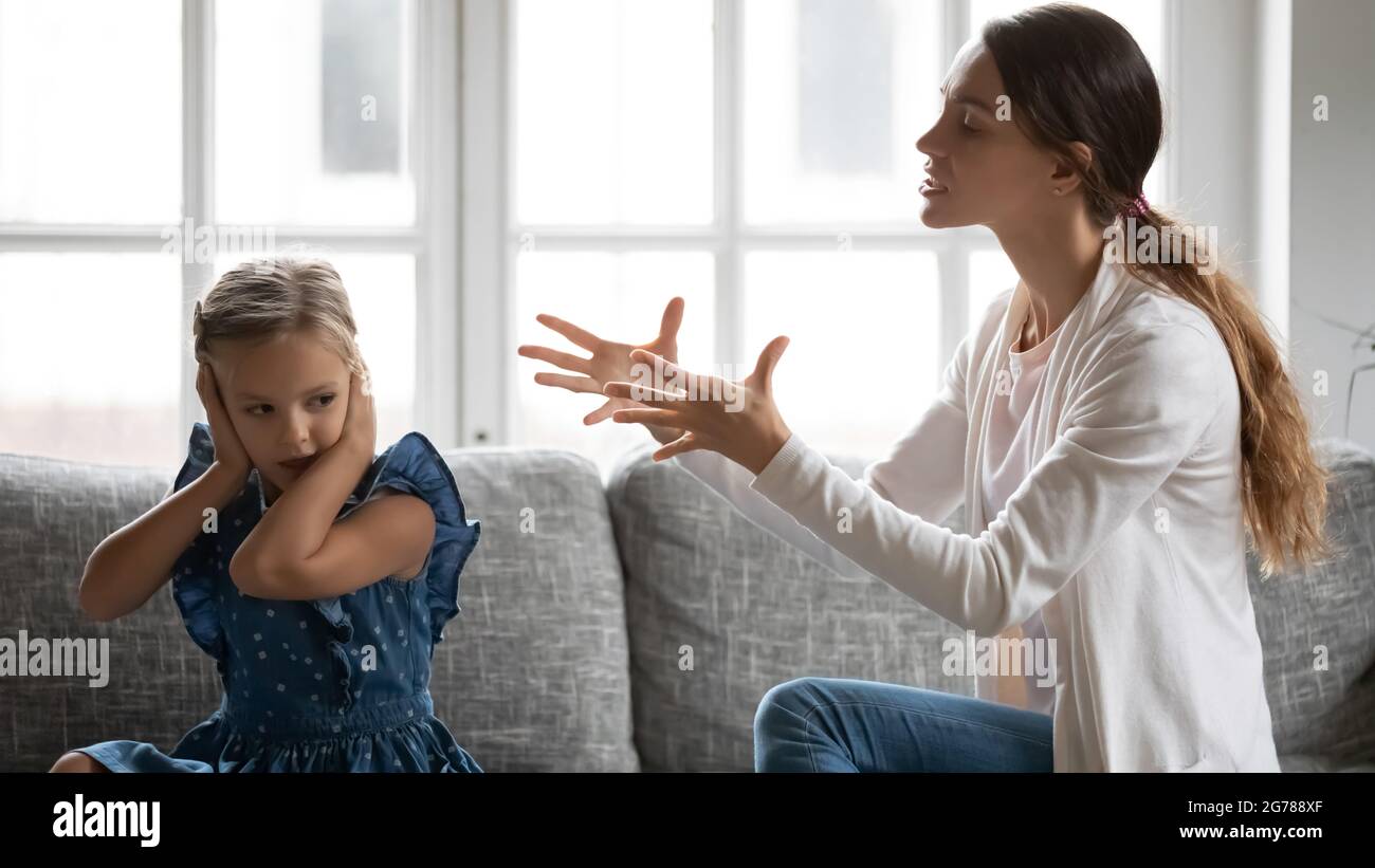 Small girl child ignore angry mom scolding Stock Photo - Alamy