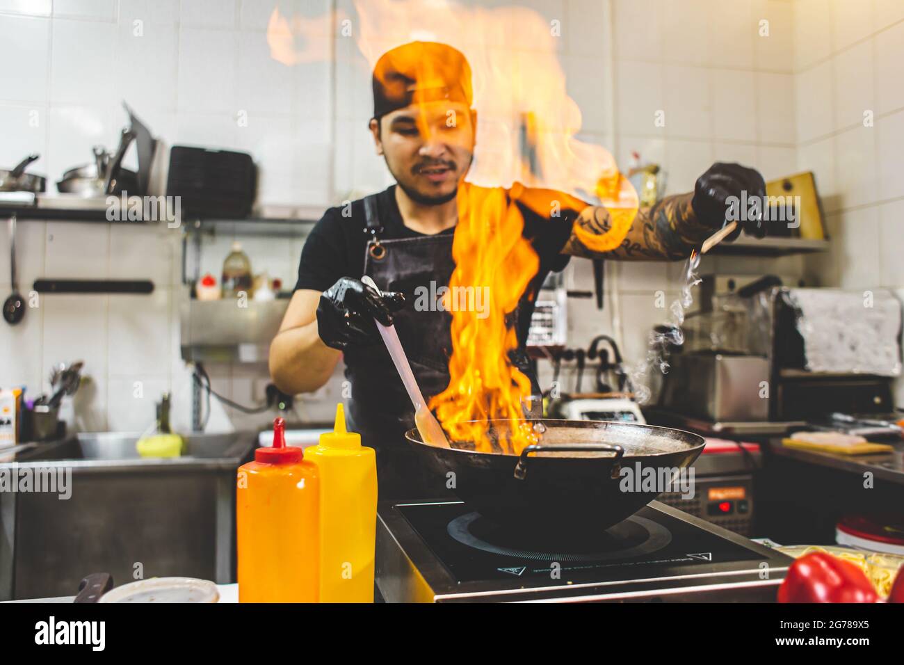 street food. fried noodles in a wok with chicken and shrimp on the open ...