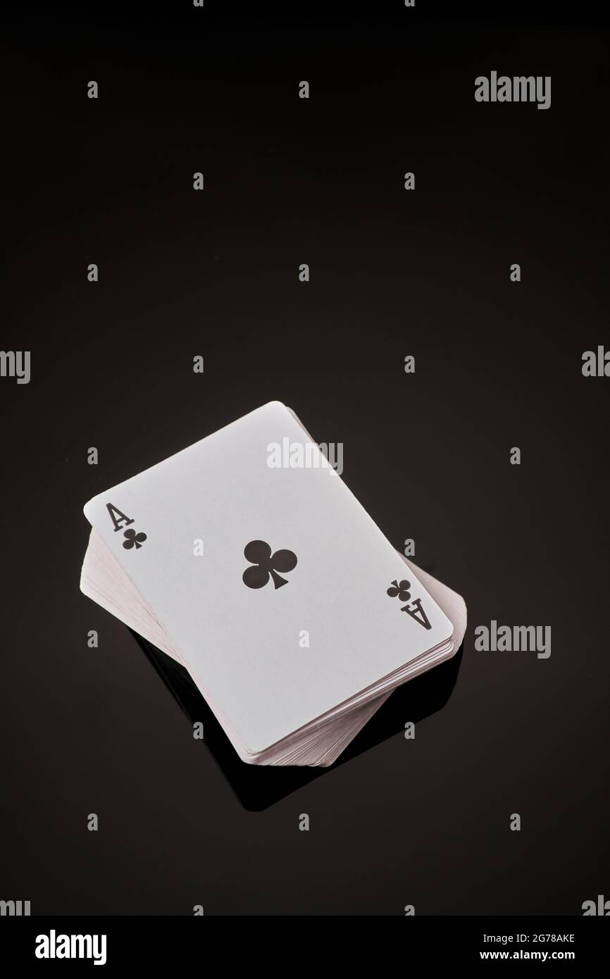 Full deck of playing cards with ace on top on dark reflective ...