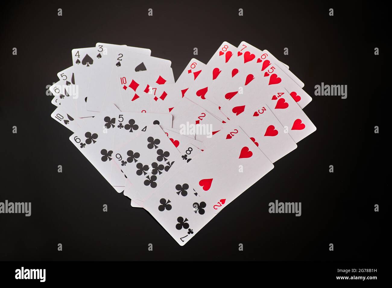 heart symbol made of playing cards dark reflective background Stock ...