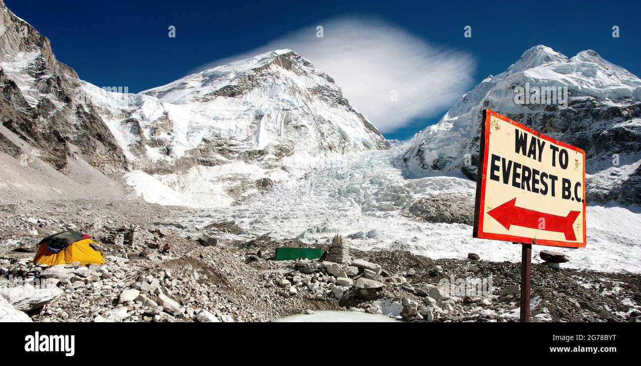 View from Mount Everest base camp, tents and prayer flags and signpost ...
