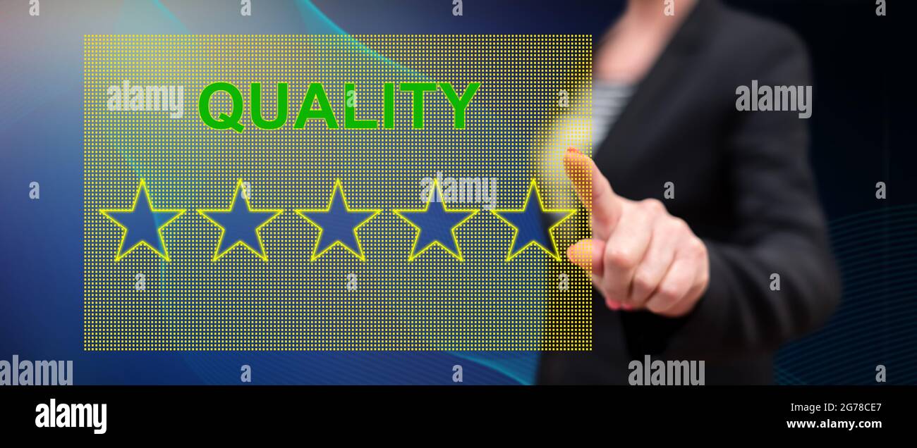 Woman touching a quality concept on a touch screen with her finger ...