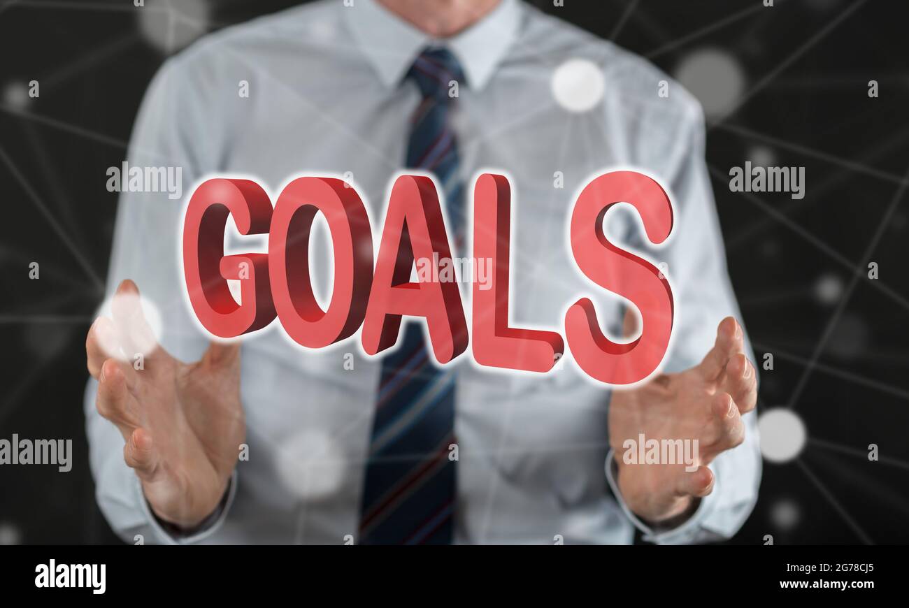Goals concept between hands of a man in background Stock Photo - Alamy