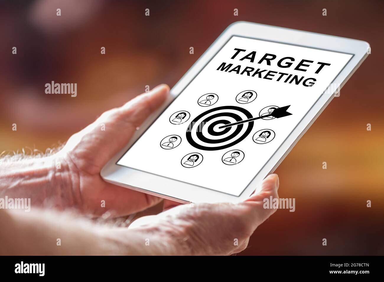 Man holding a tablet showing target marketing concept Stock Photo - Alamy