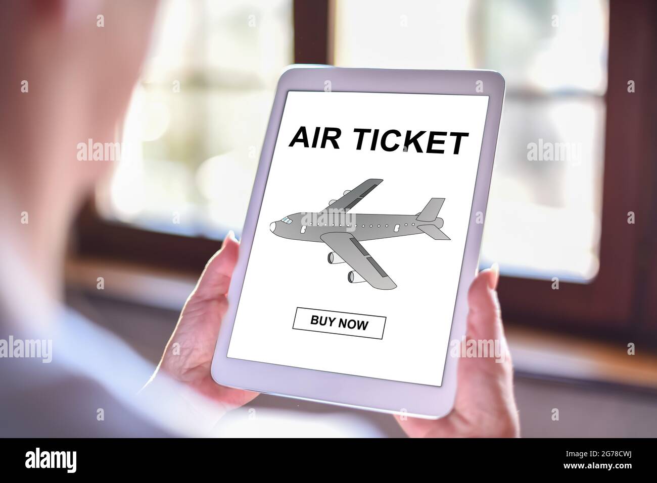 Tablet screen displaying an air ticket booking concept Stock Photo - Alamy