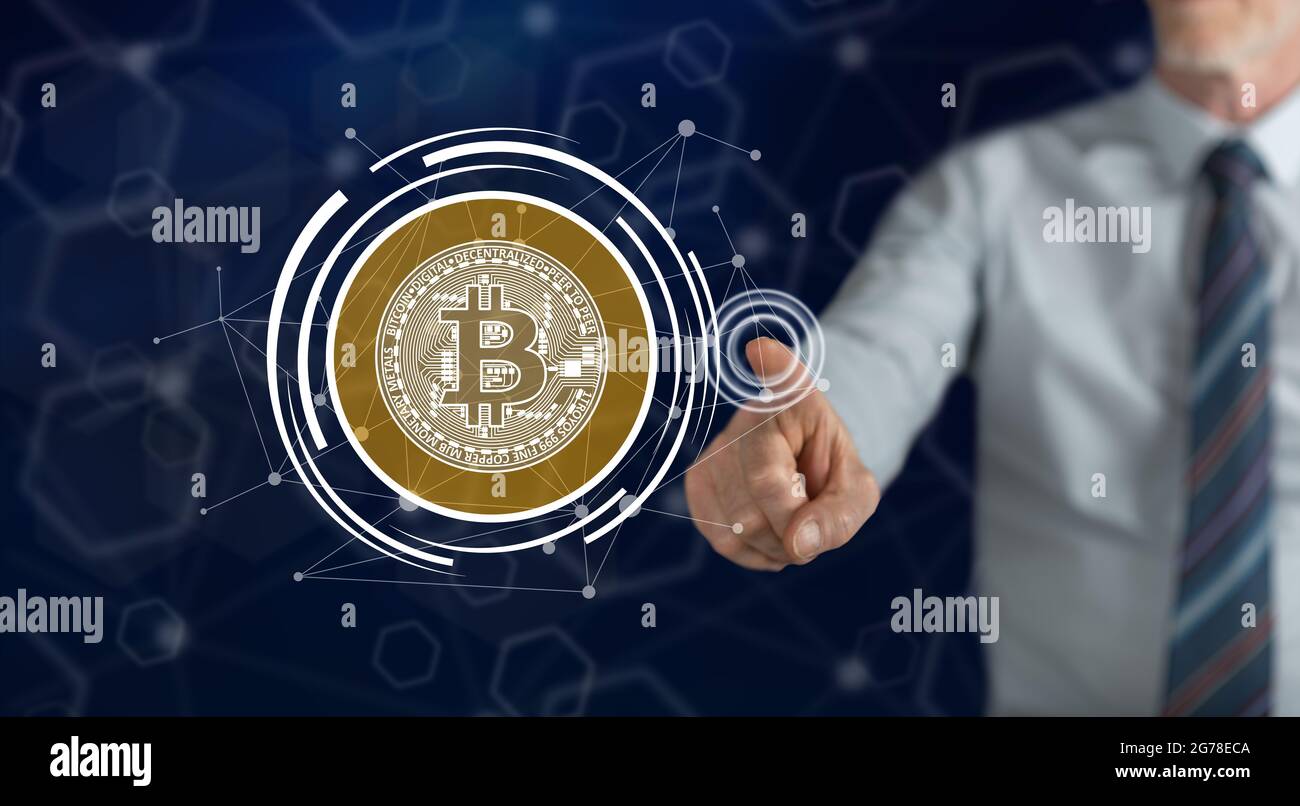 Man touching a bitcoin currency concept on a touch screen with his ...