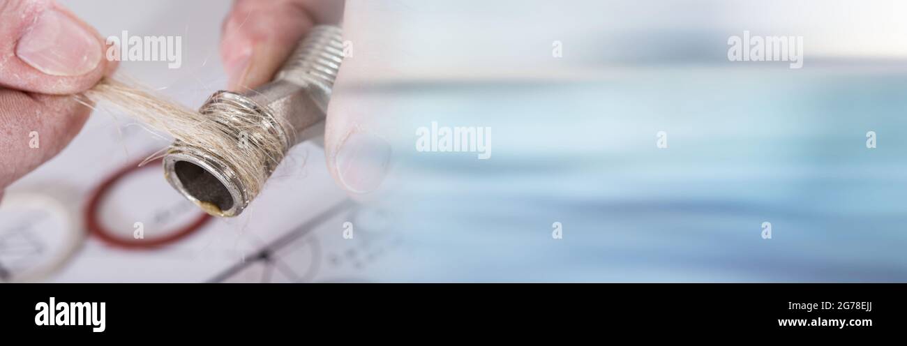 Hand putting hemp fibers on a thread, blurred background Stock Photo ...