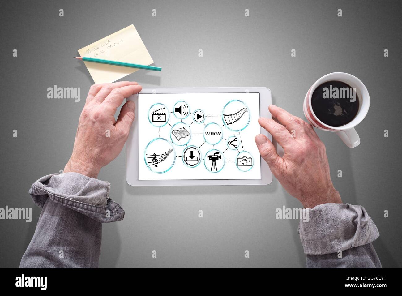 Male hands using a tablet showing social information sharing concept ...