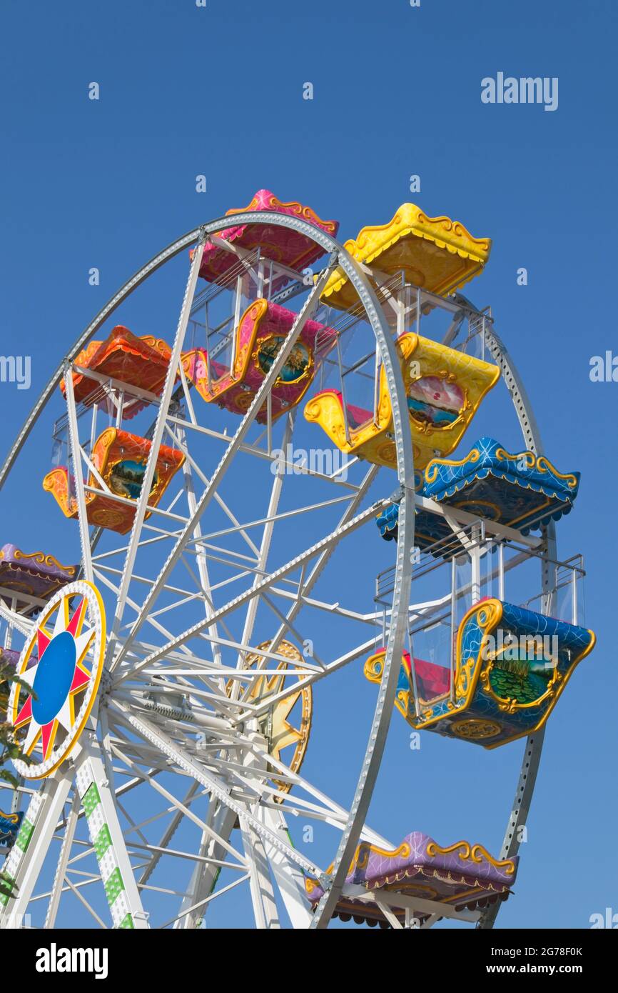 Ferris wheel against blue sky with colorful empty cabins Stock Photo ...