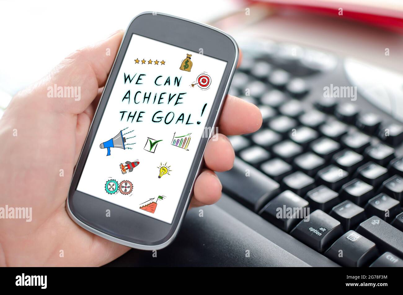 Hand holding a smartphone showing a goal achievement concept Stock ...