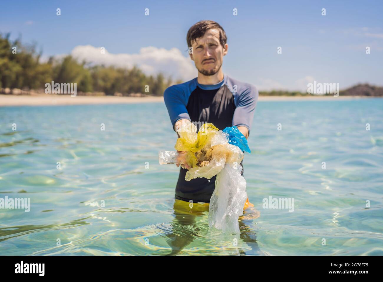 Man collects packages from the beautiful turquoise sea. Paradise beach ...